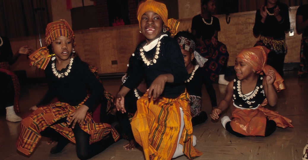 man-with-wrapped-gifts - Kwanzaa Pictures - Kwanzaa - HISTORY.com